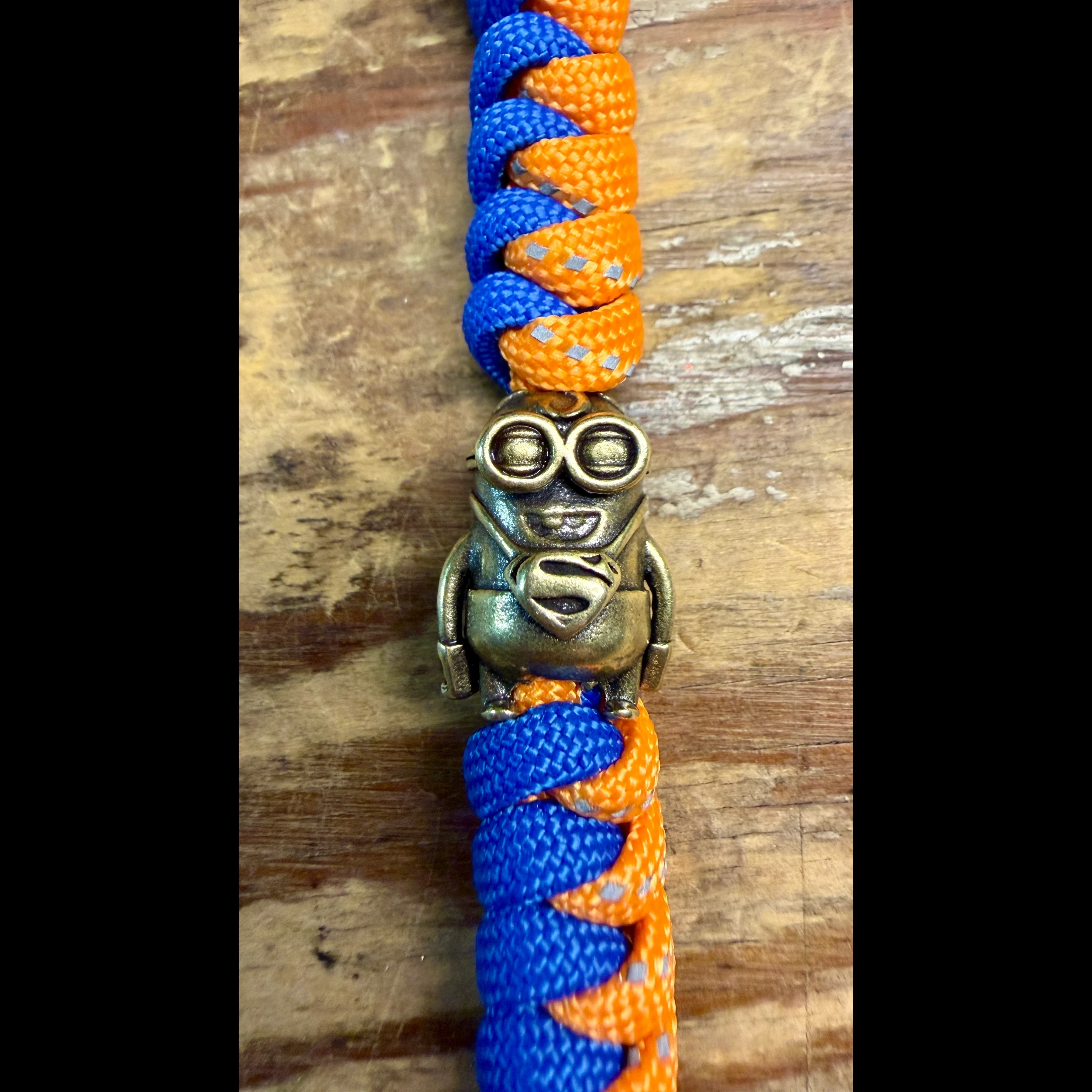 Bladebinge - Minion bead on a blue and orange paracord lanyard.