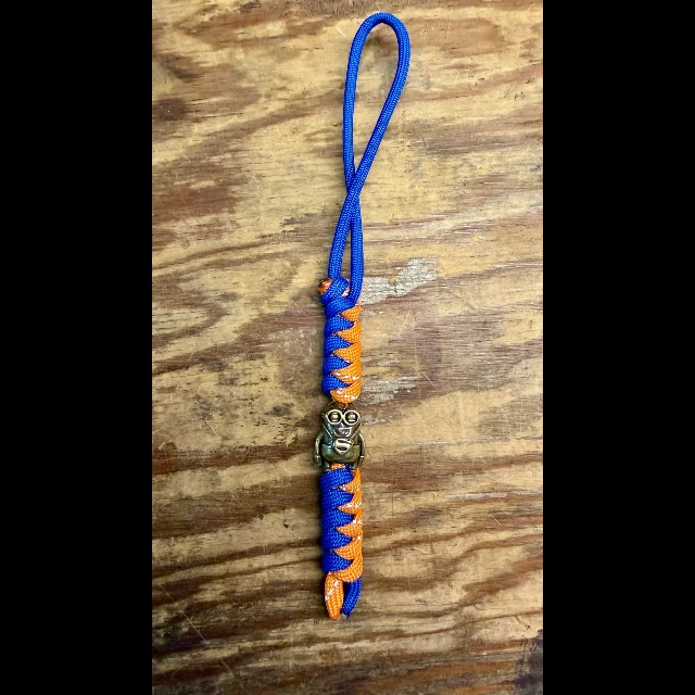 Bladebinge - Minion bead on a blue and orange paracord lanyard.